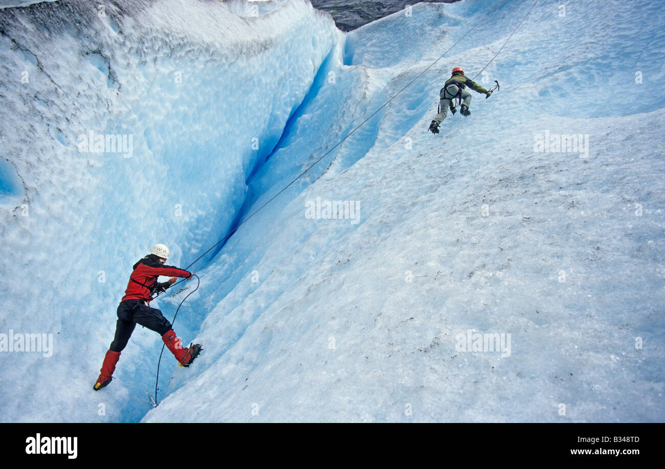 woman is learning ice climbing on the glacier Briksdalsbreen tongue of ...