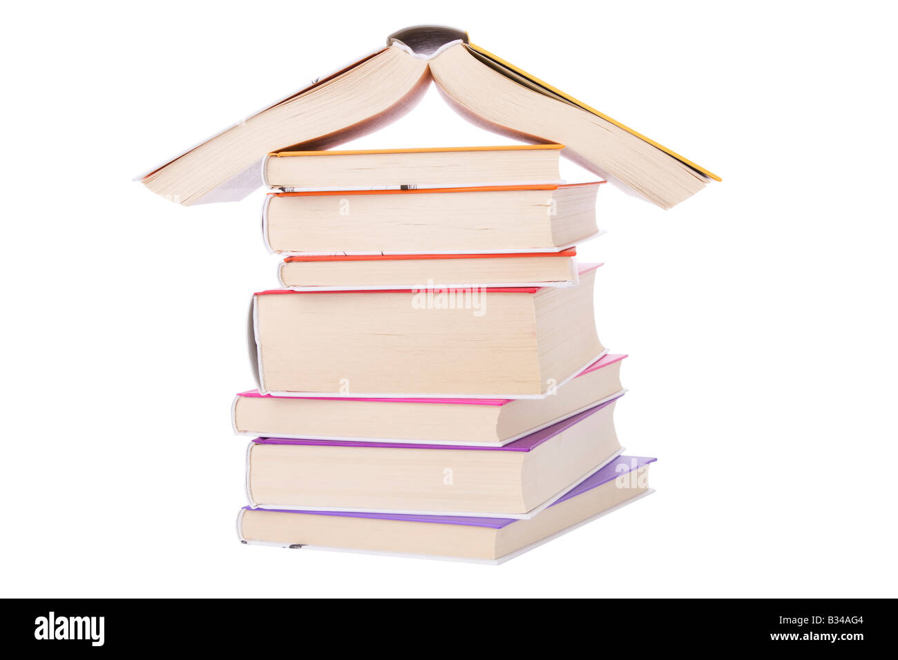 House made with books piled on white background Stock Photo - Alamy