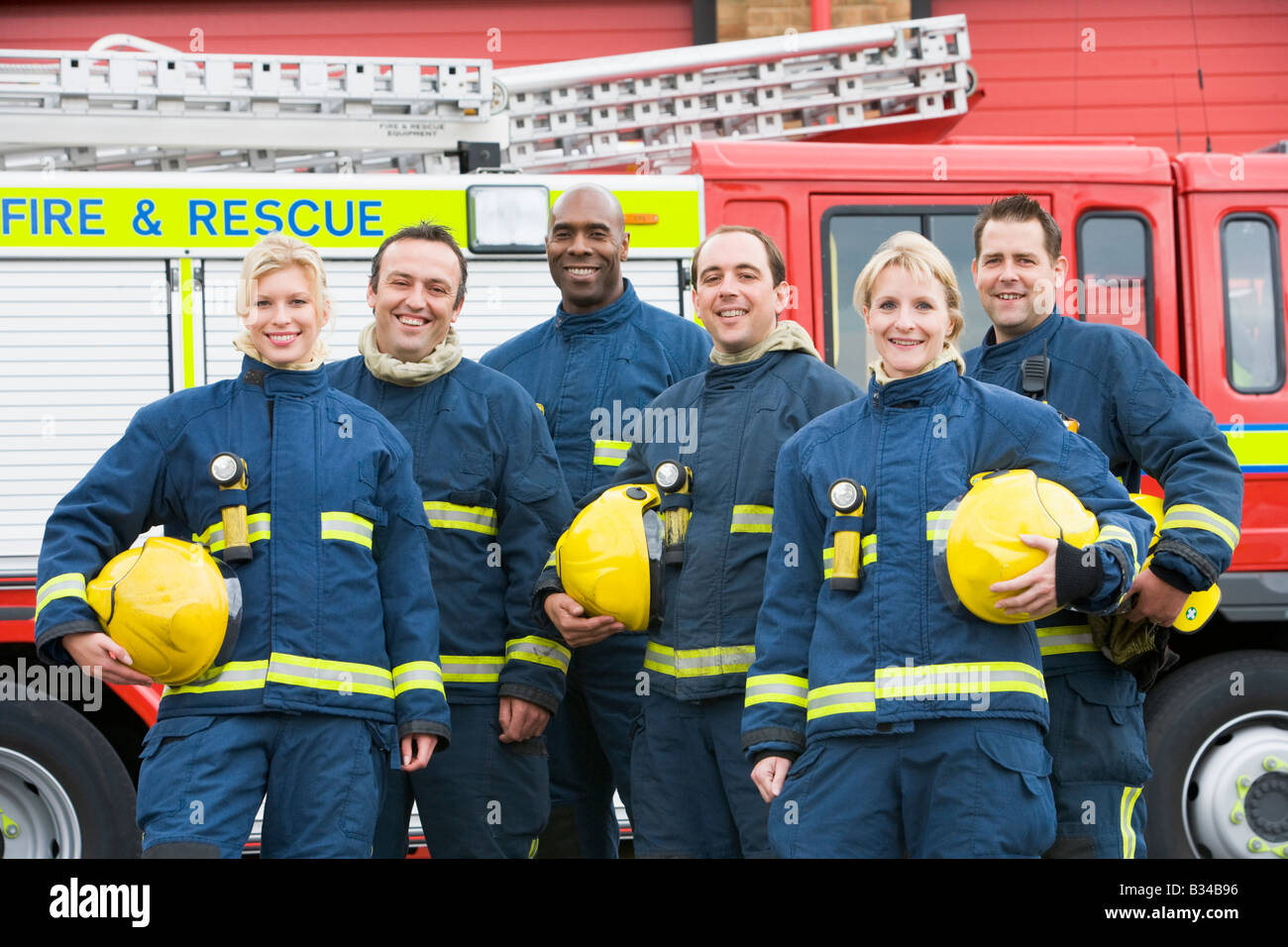 Six firefighters standing by fire engine Stock Photo - Alamy