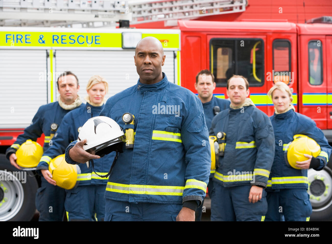 Six firefighters standing by fire engine Stock Photo - Alamy