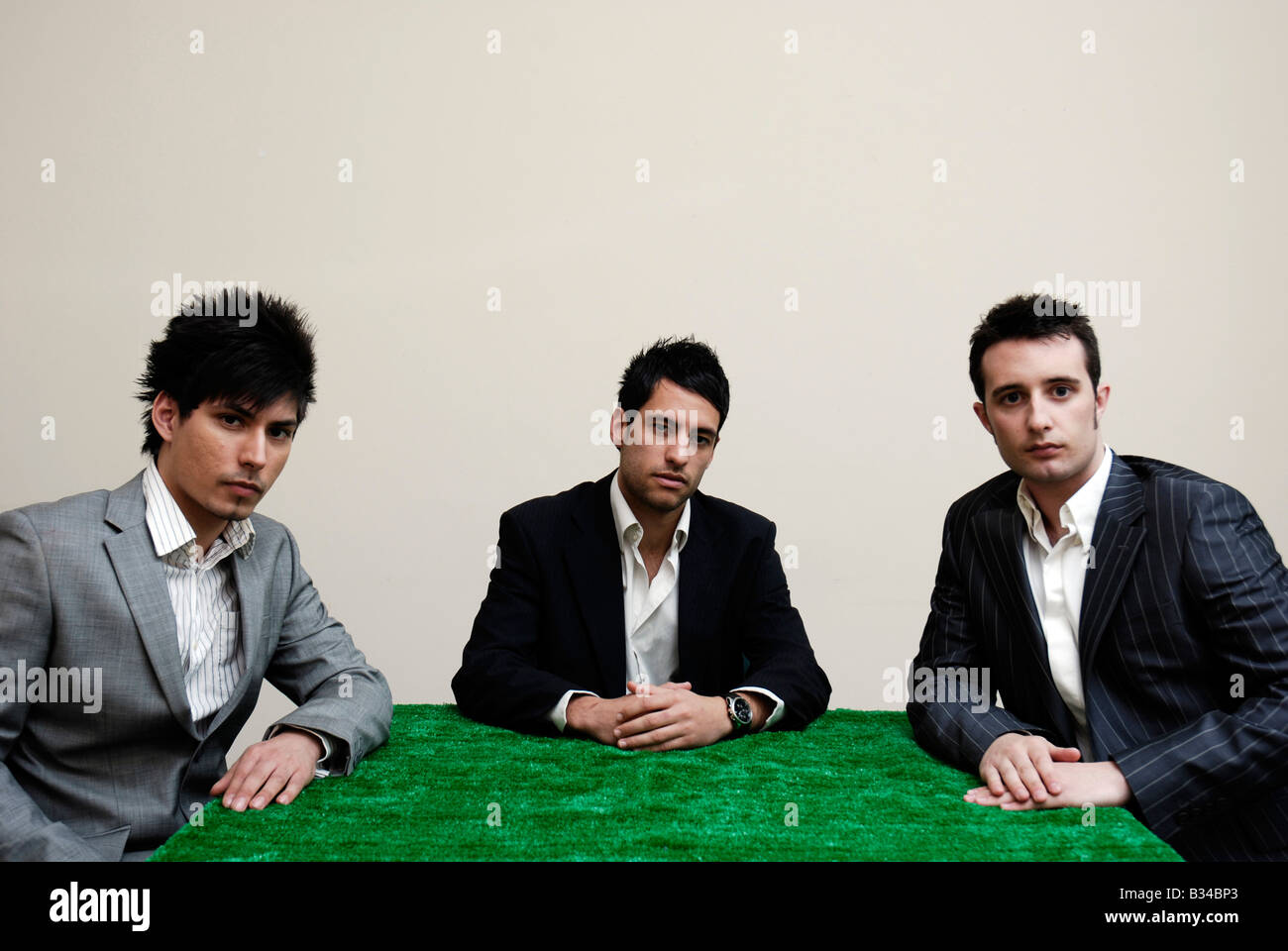 A group of young businessmen contemplating environmental issues and ...