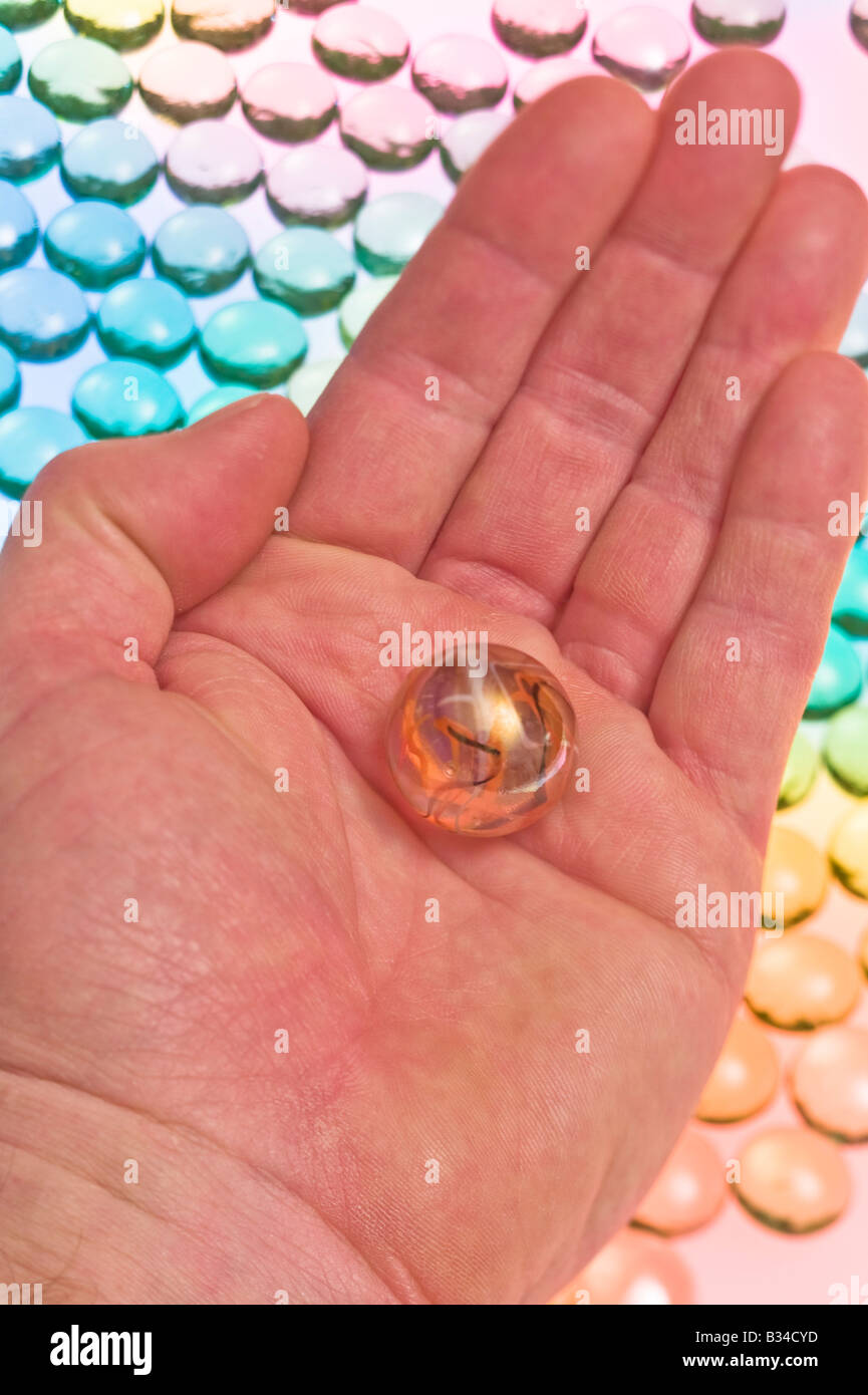 Hand holding a glass marble Stock Photo - Alamy