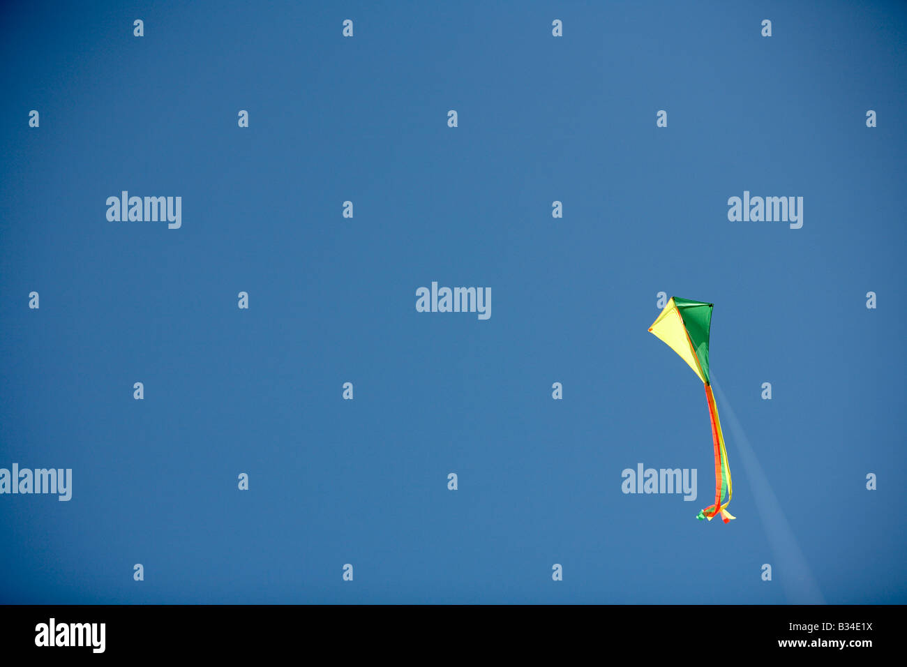 KITE SHAPED KITE AGAINST A BLUE SKY Stock Photo - Alamy