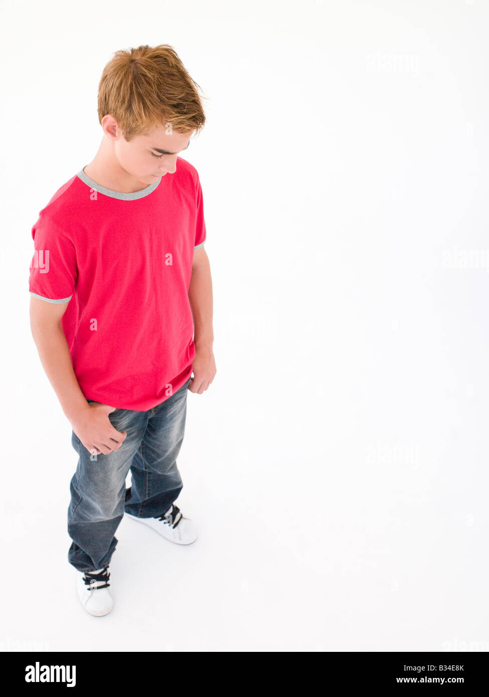 Teenage boy looking down Stock Photo - Alamy