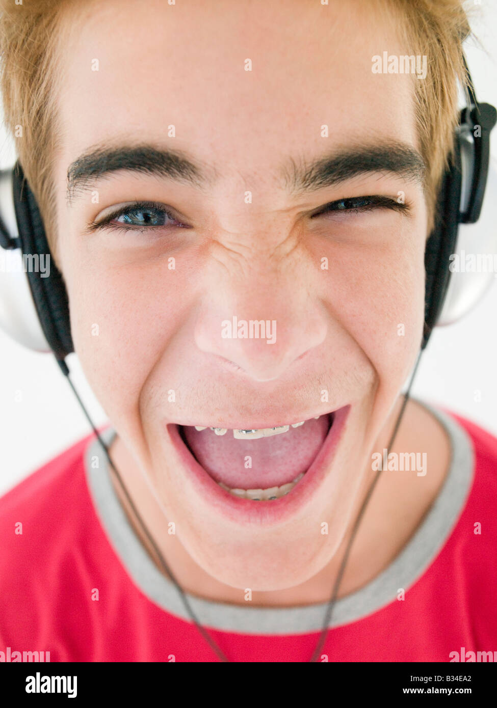 Teenage boy wearing headphones and smiling Stock Photo - Alamy