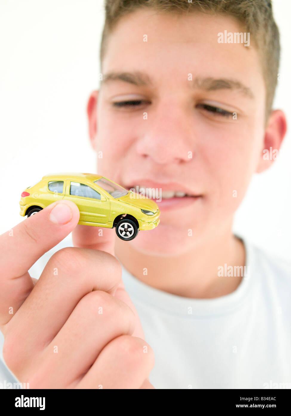 Young boy holding toy car and smiling Stock Photo - Alamy