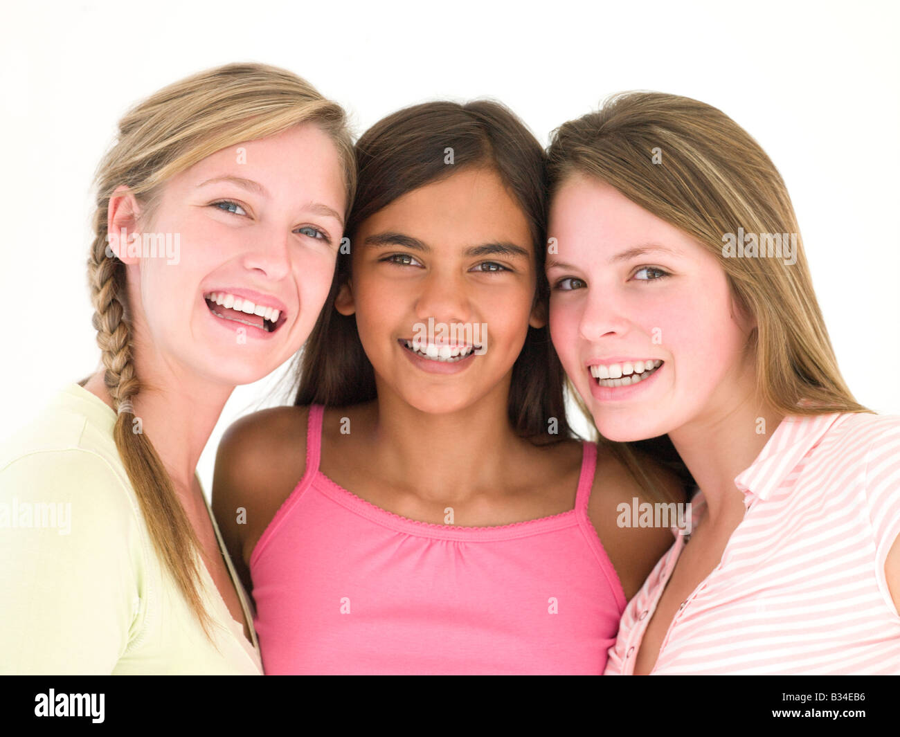Three girl friends together smiling Stock Photo - Alamy