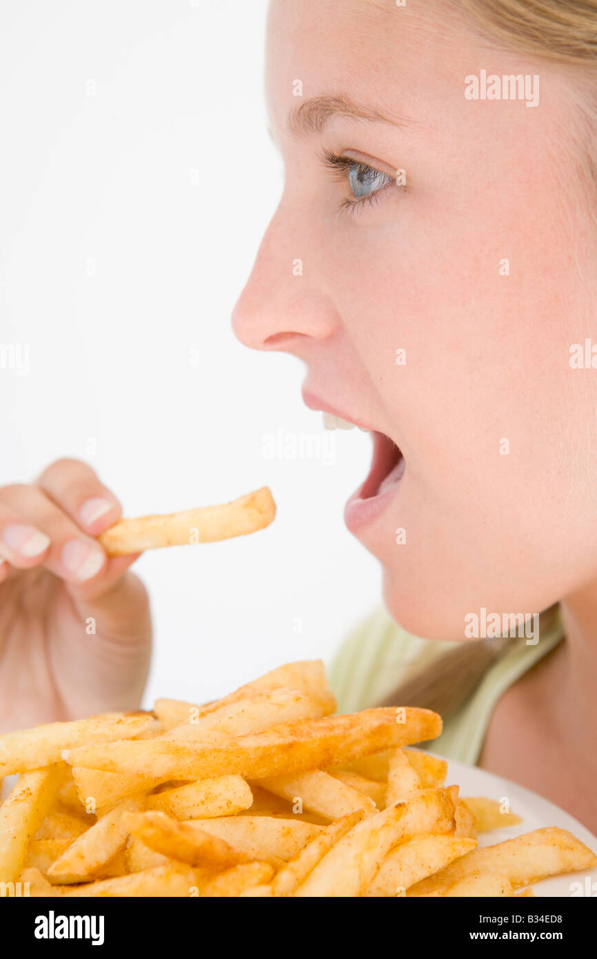 Teenage girl eating French fries Stock Photo - Alamy