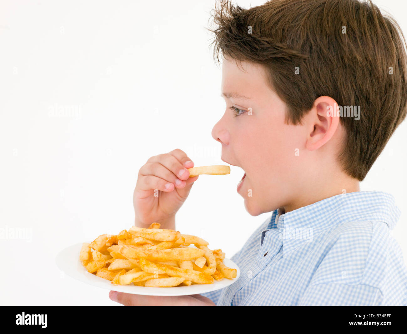 Boy eating french fries hi-res stock photography and images - Alamy