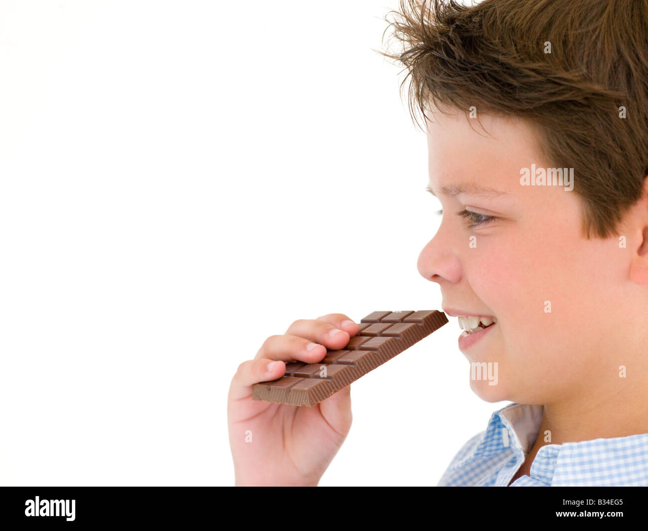 Young boy eating chocolate bar Stock Photo - Alamy