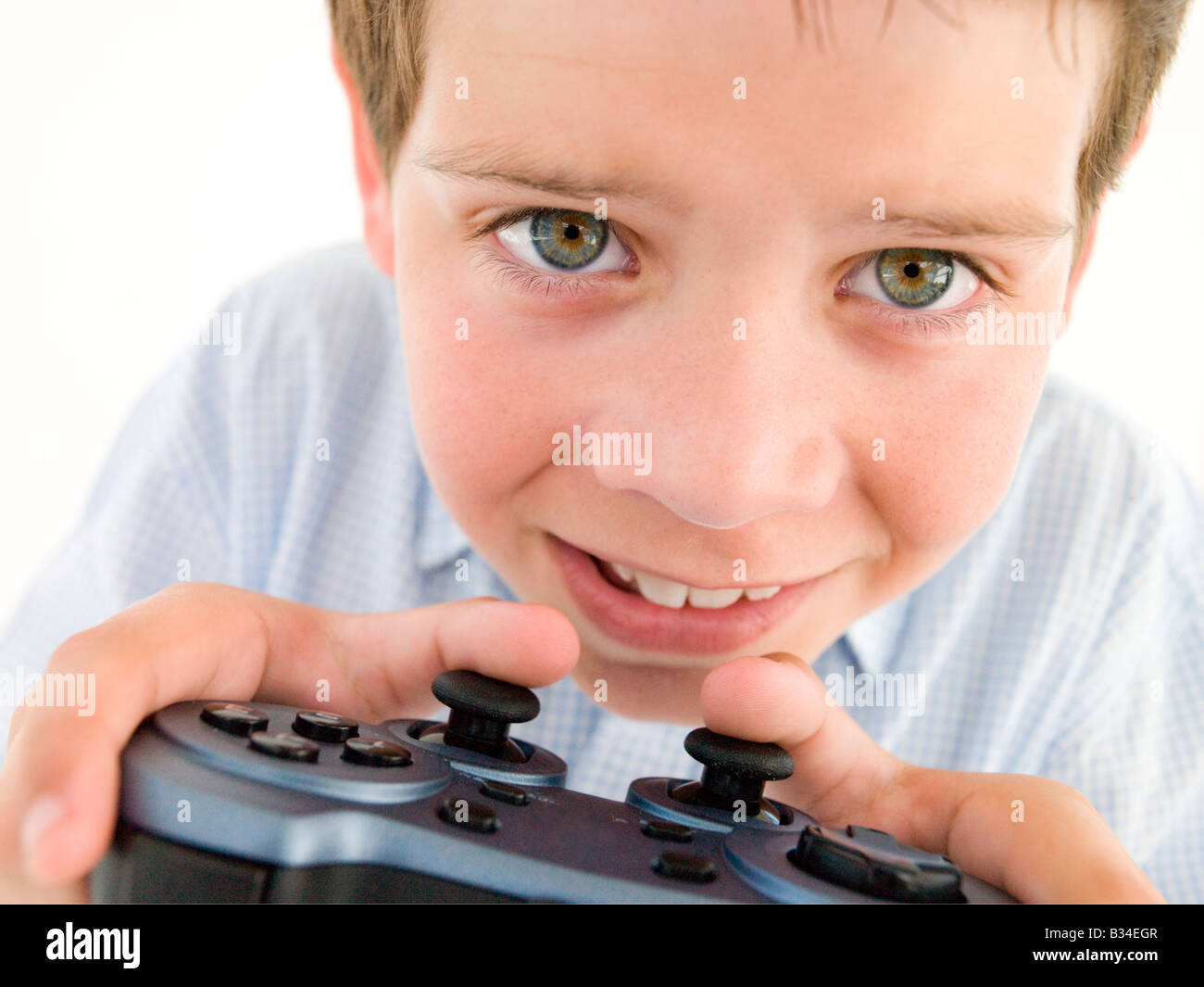 Young boy using videogame controller smiling Stock Photo - Alamy
