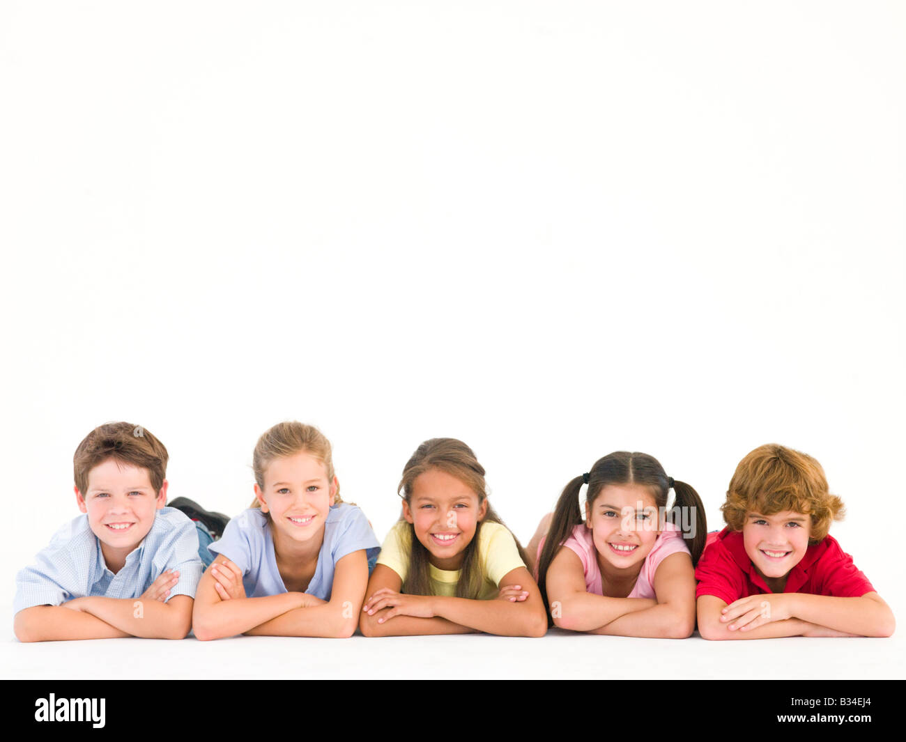Row of five friends lying down smiling Stock Photo - Alamy