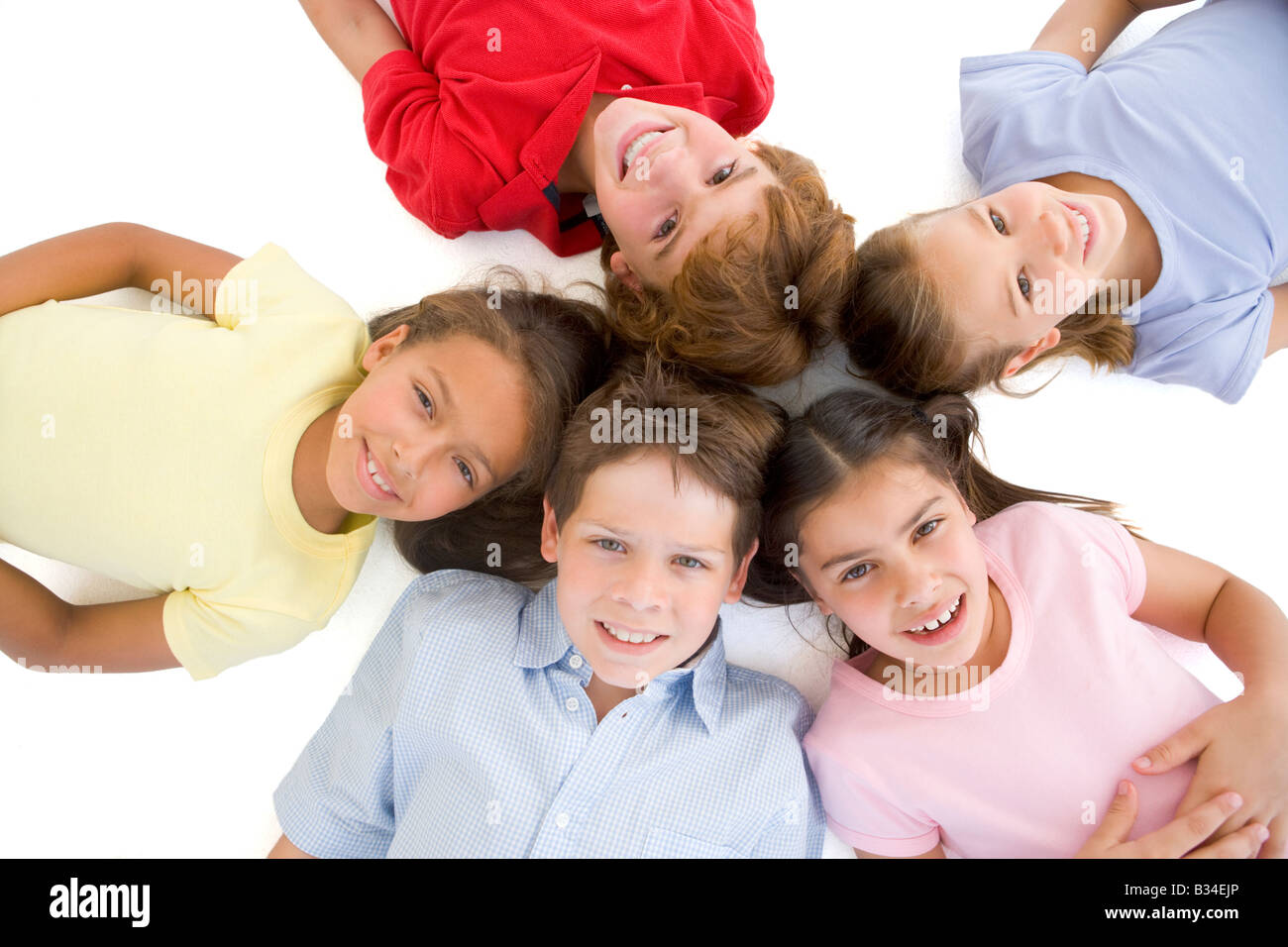 Circle of five young friends smiling Stock Photo - Alamy