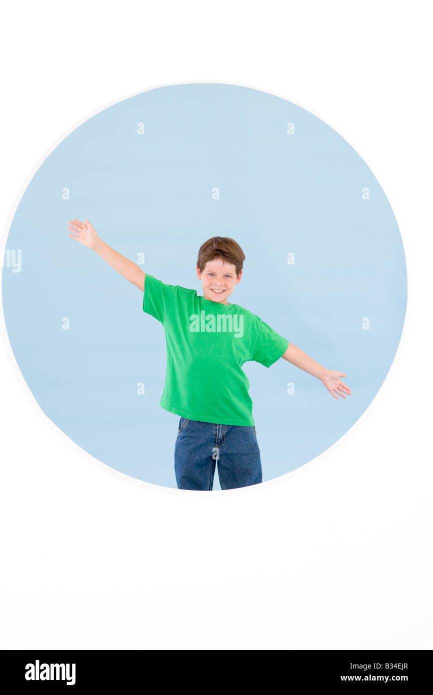 Young boy standing with arms out smiling Stock Photo - Alamy