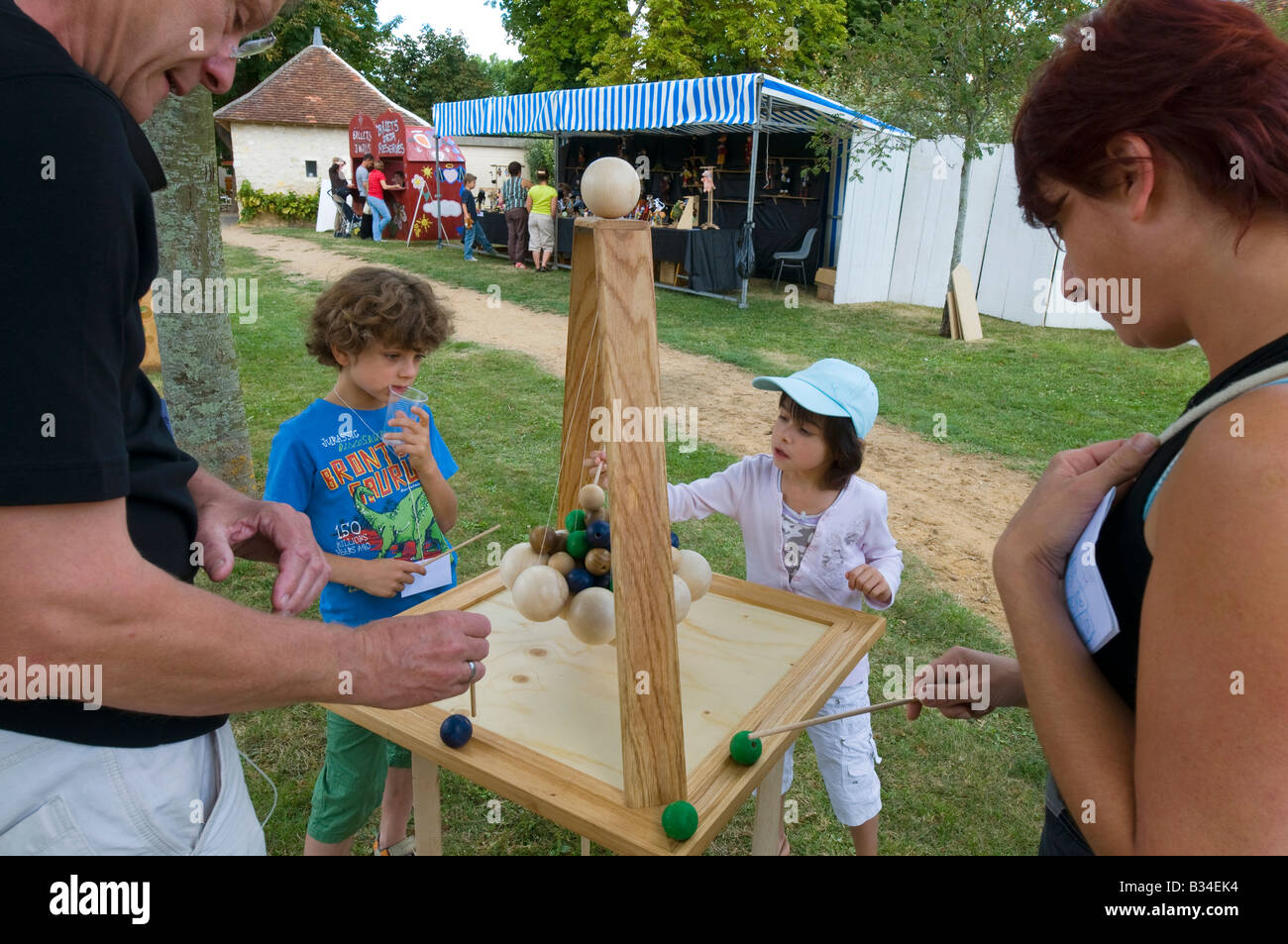 Wooden ball game at children's fair, France Stock Photo - Alamy