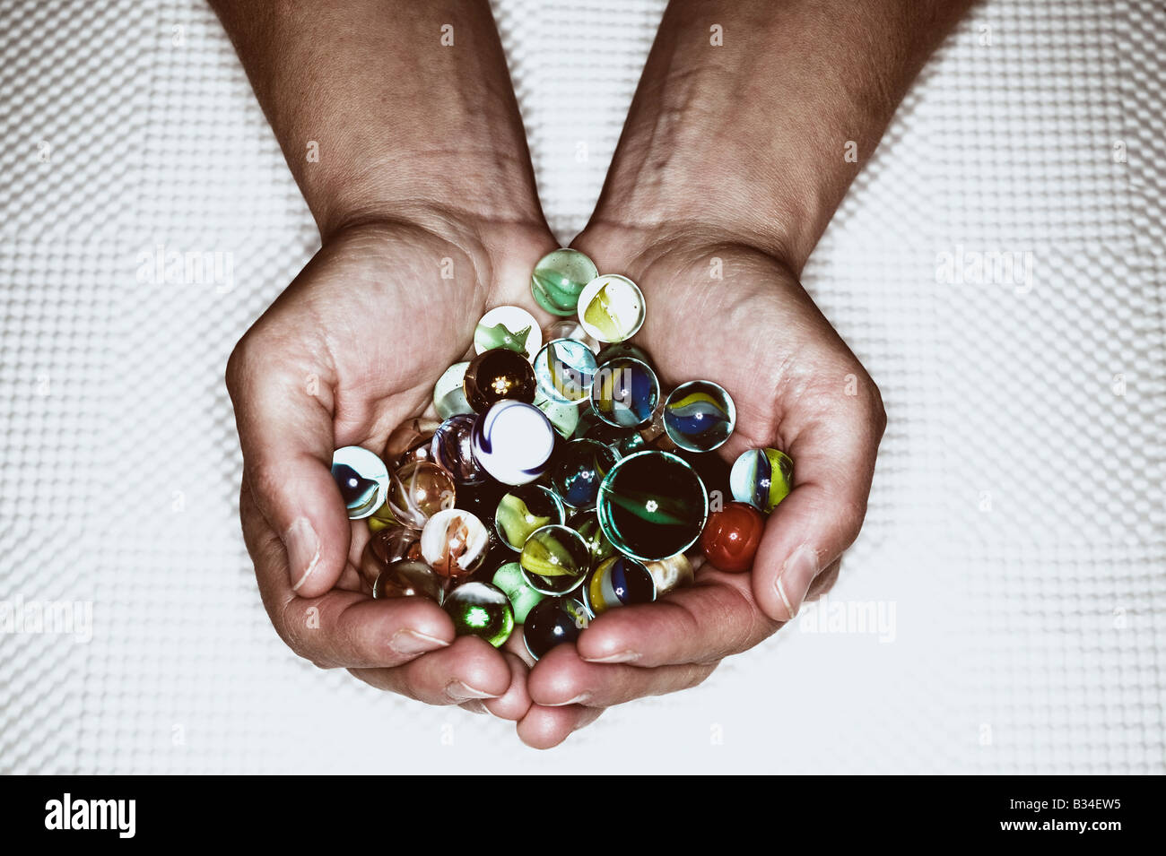 Hand holding marbles hi-res stock photography and images - Alamy
