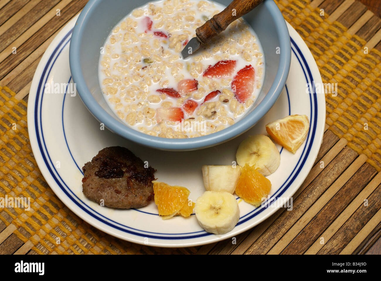Breakfast Cereal with fruit and meat Sausage Stock Photo - Alamy