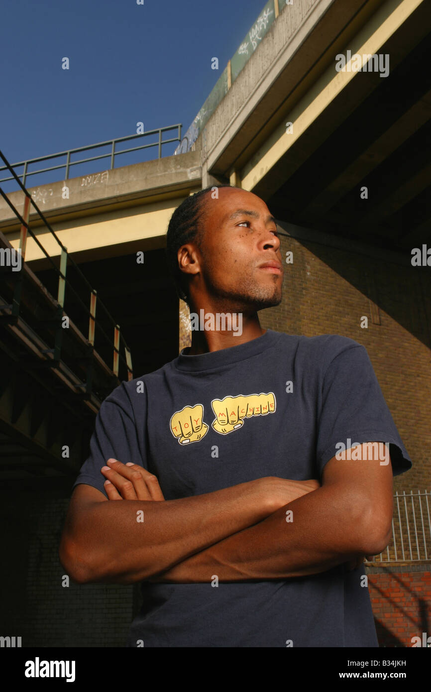 Man with folded arms under inner city railway subway and bridges Stock ...