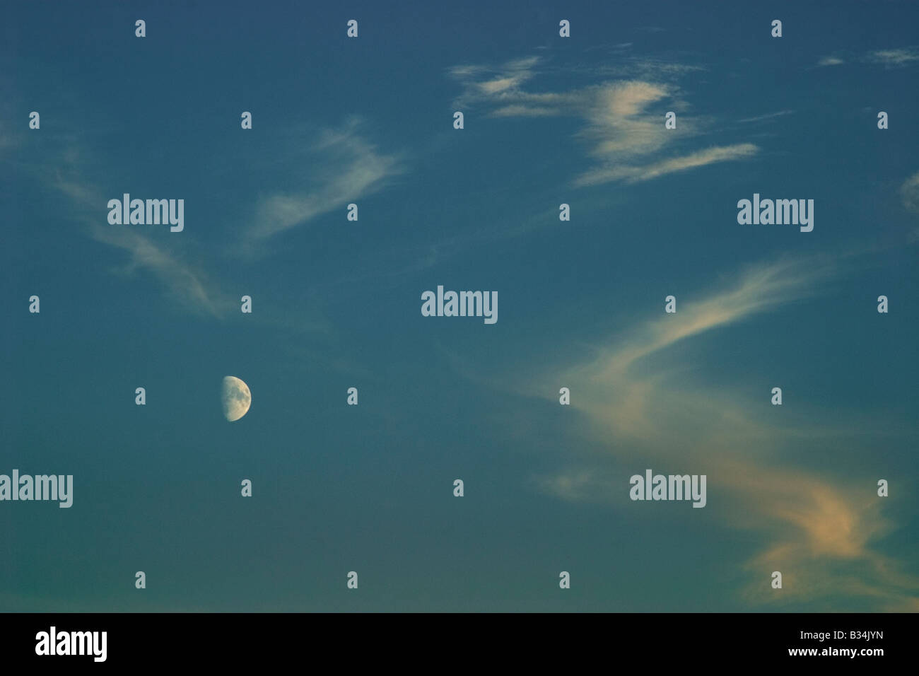 Moon and cloud in a late evening sunset Stock Photo - Alamy