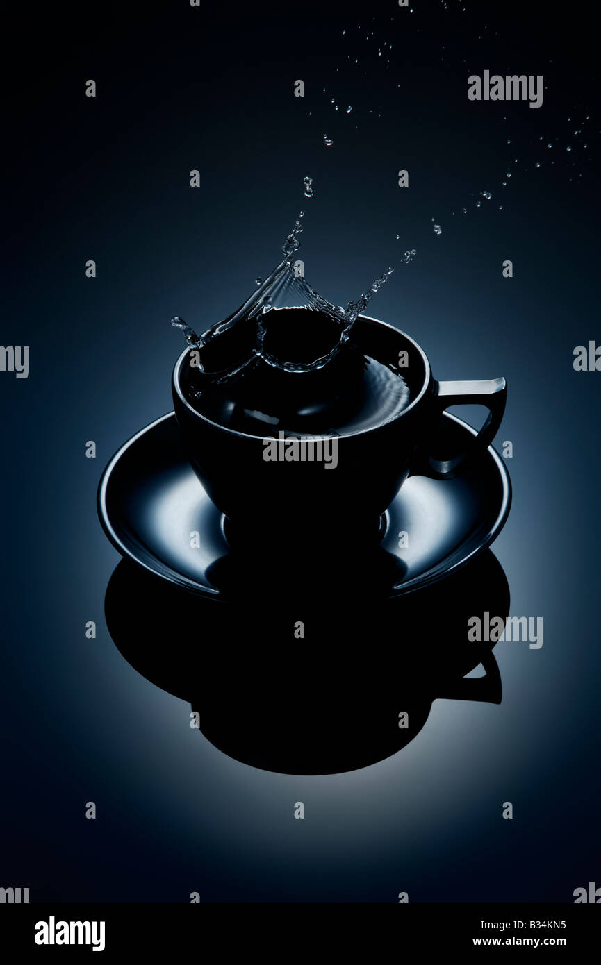 Water splash out of coffee cup Stock Photo - Alamy