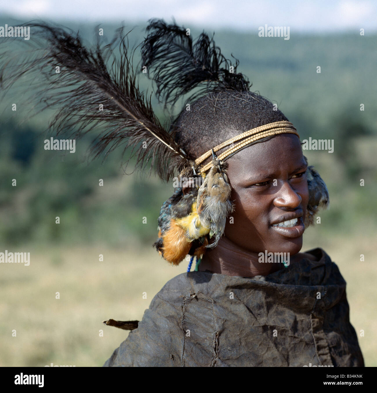 Kenya, Samburu District, Maralal. A Samburu initiate with bird skins ...