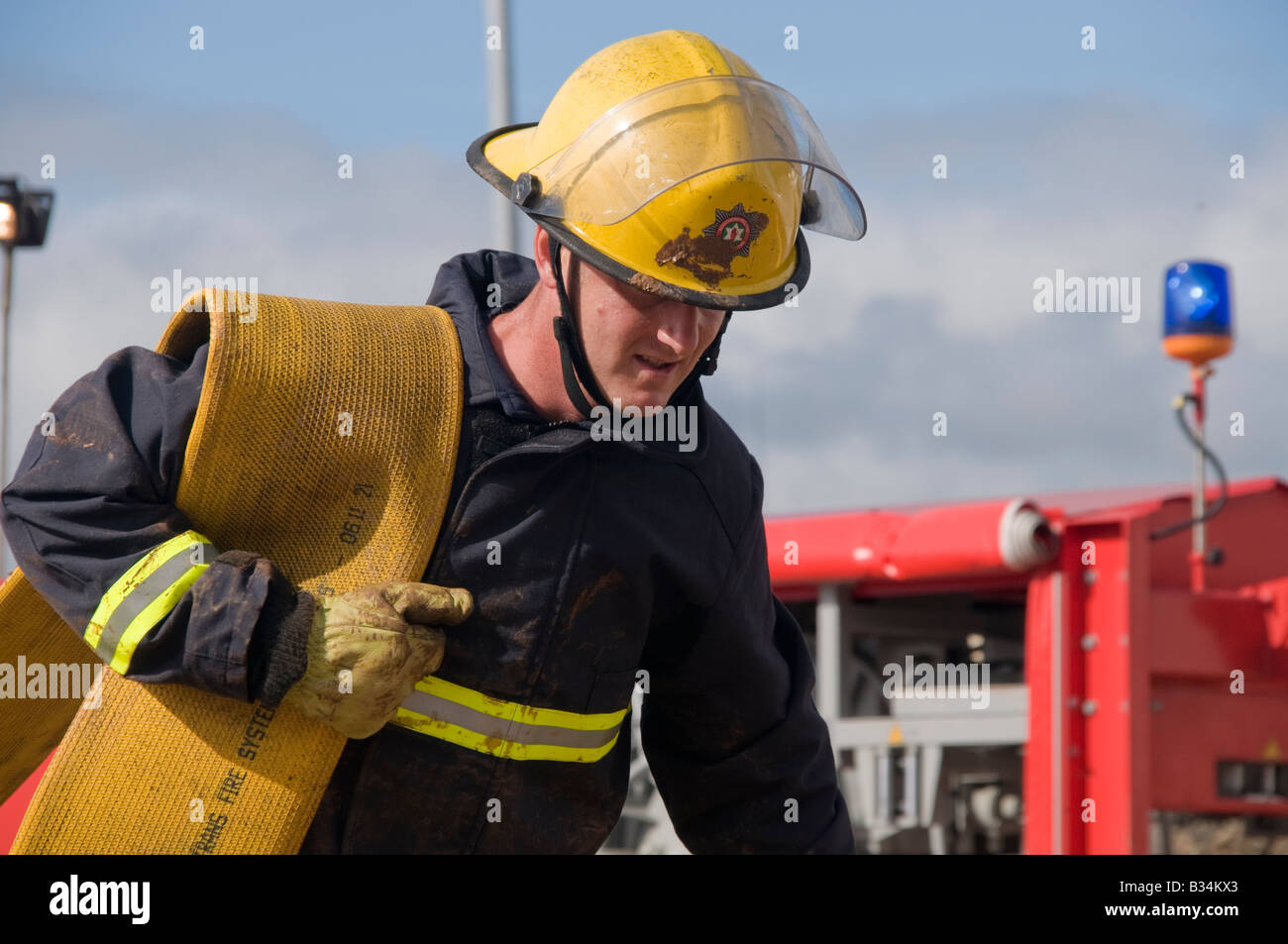 Fireman with hose hi-res stock photography and images - Alamy