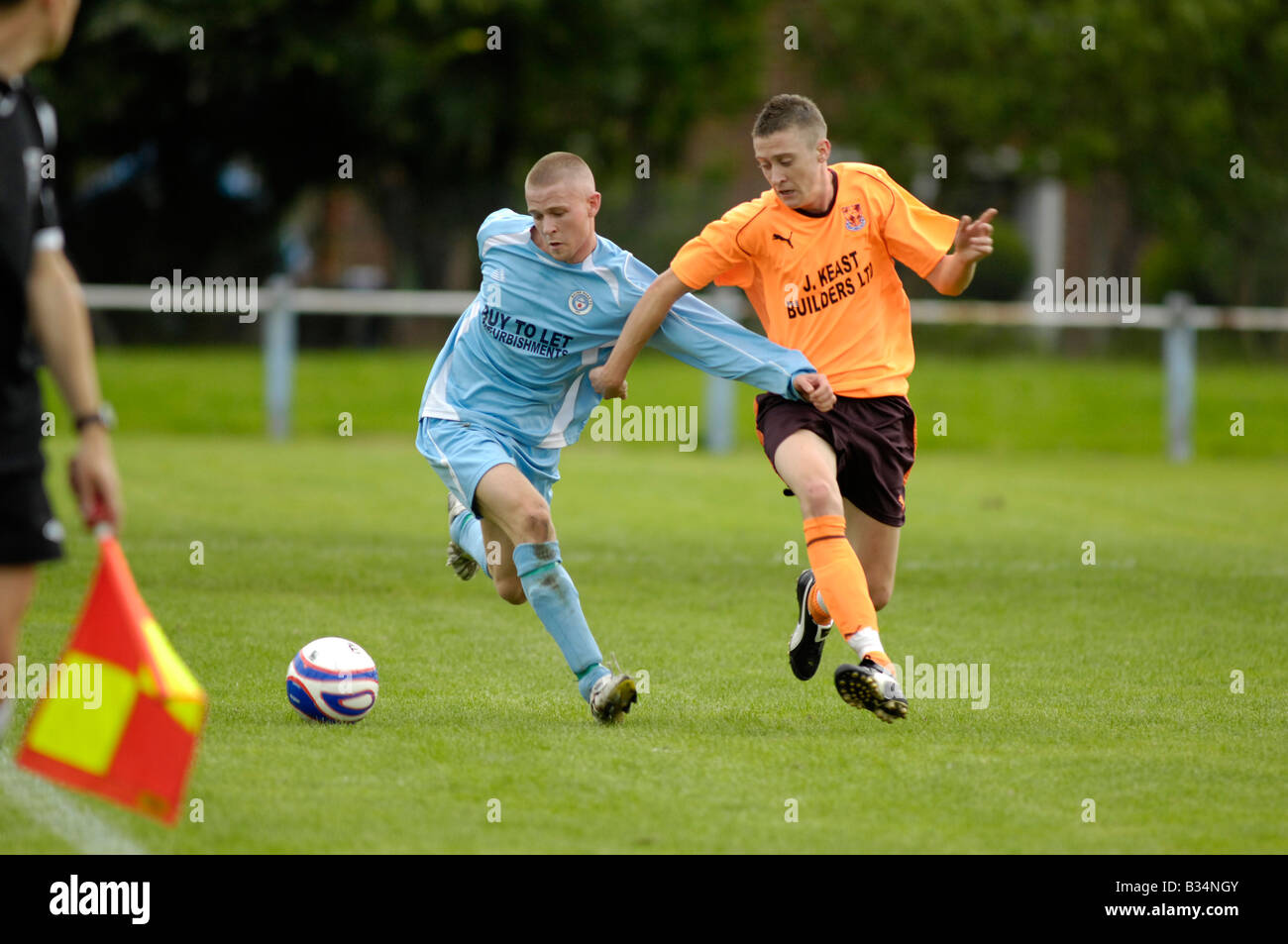 two footballers battling for the ball Stock Photo - Alamy