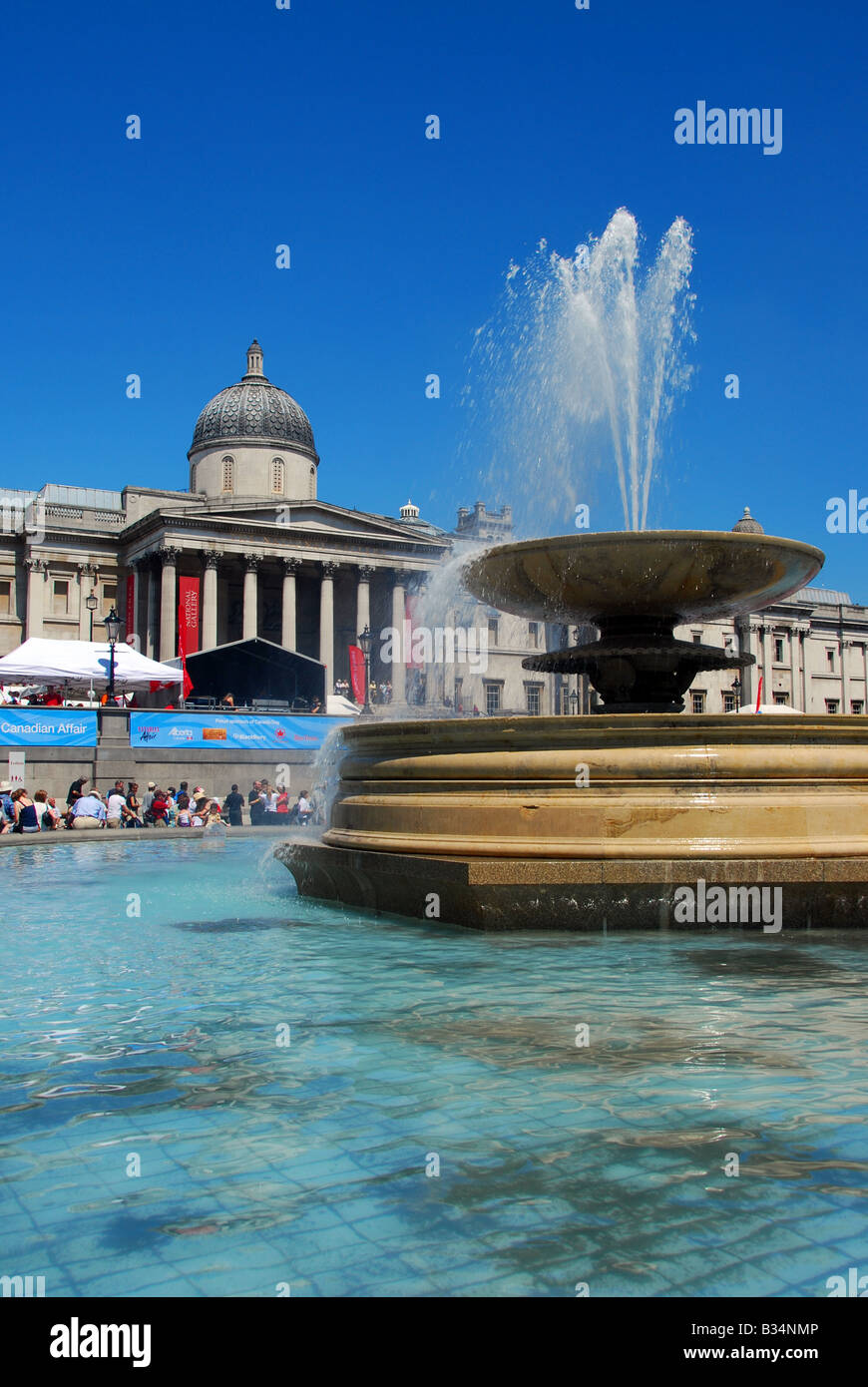 The fountains of Trafalgar Square, London, with the National Gallery in ...