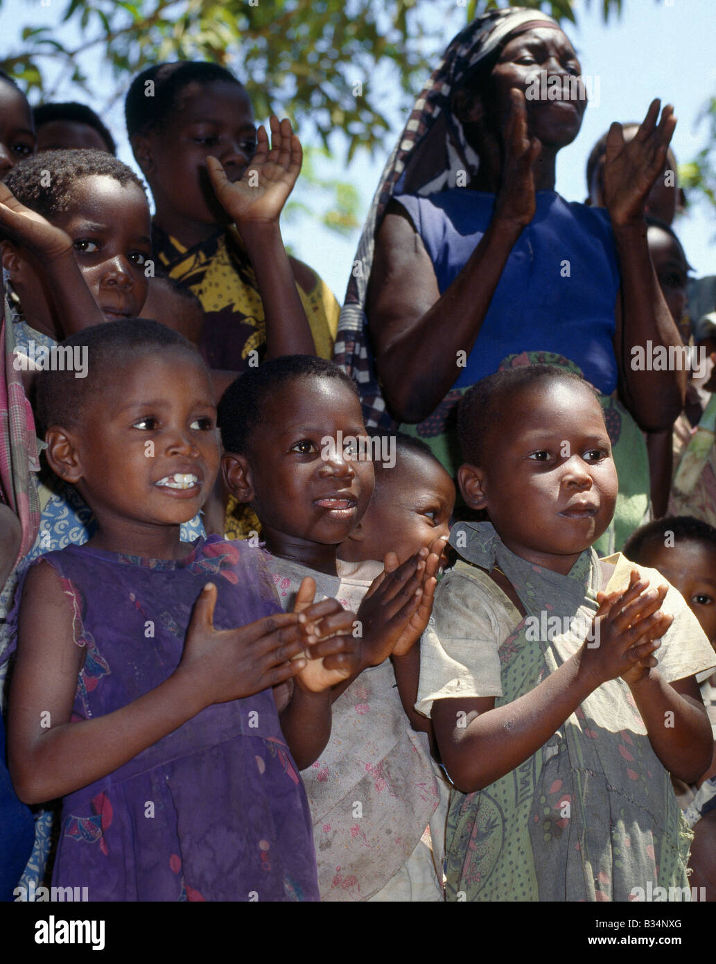 Kenya, Tana River, Ngao. Pokomo women and children clapping to the ...