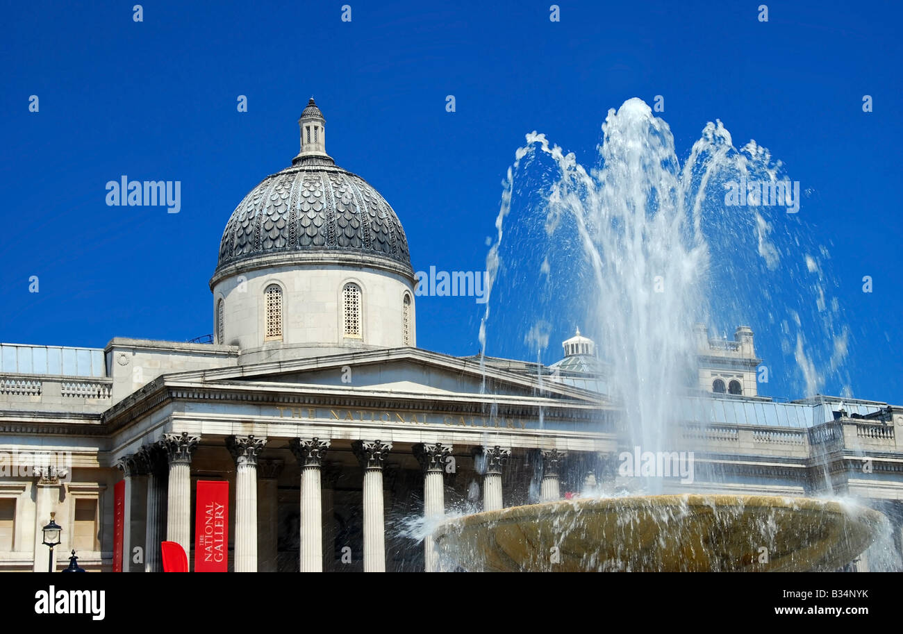 Fountain in Trafalgar Square with National Portrait Gallery in ...