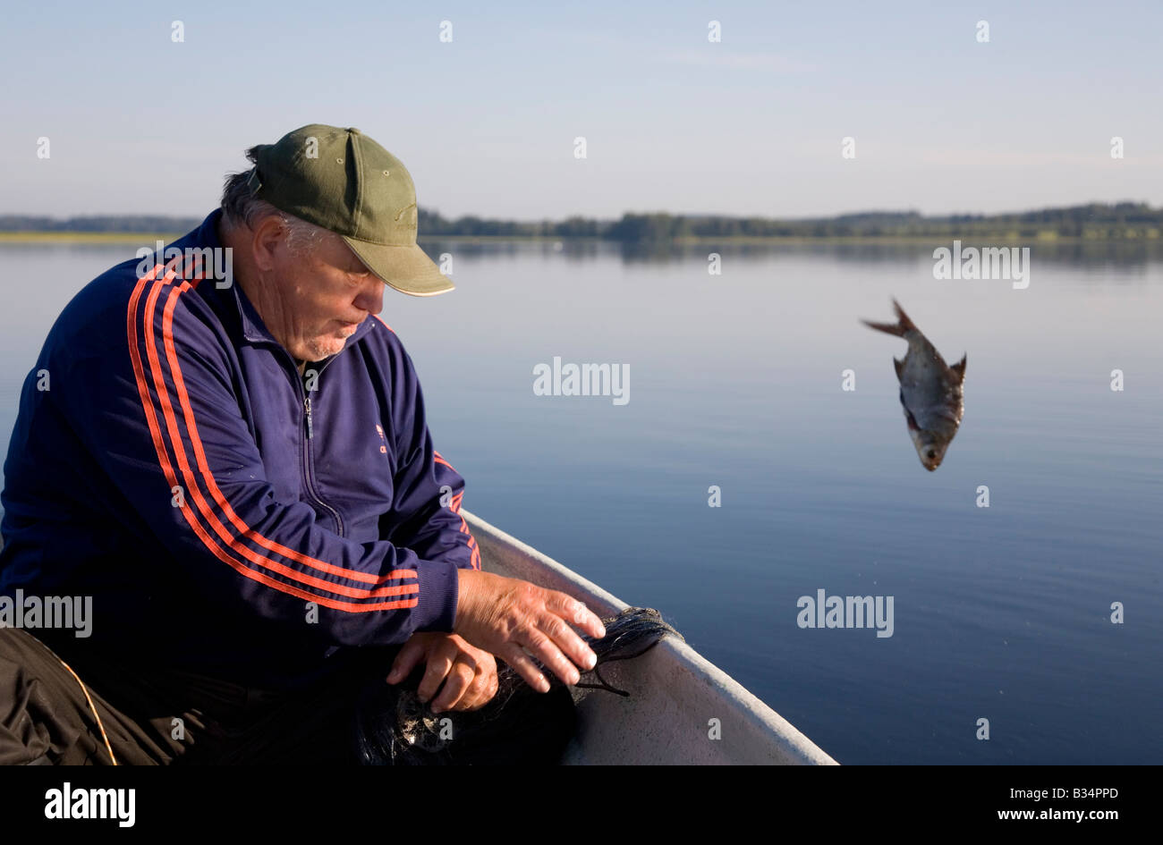 Old senior man fisherman net catch fish alone senior adult hi-res stock ...