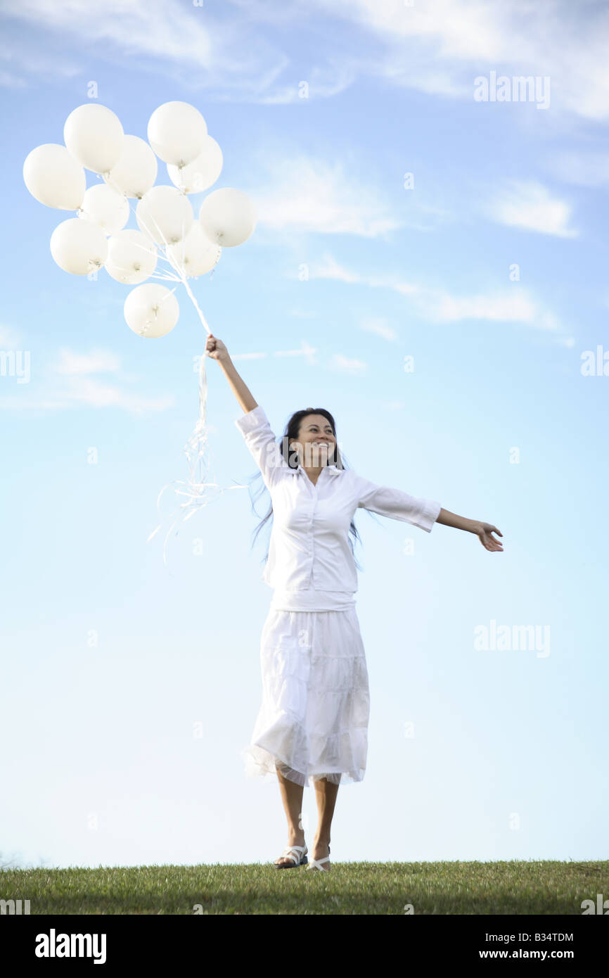 Asian woman with white balloons Stock Photo - Alamy