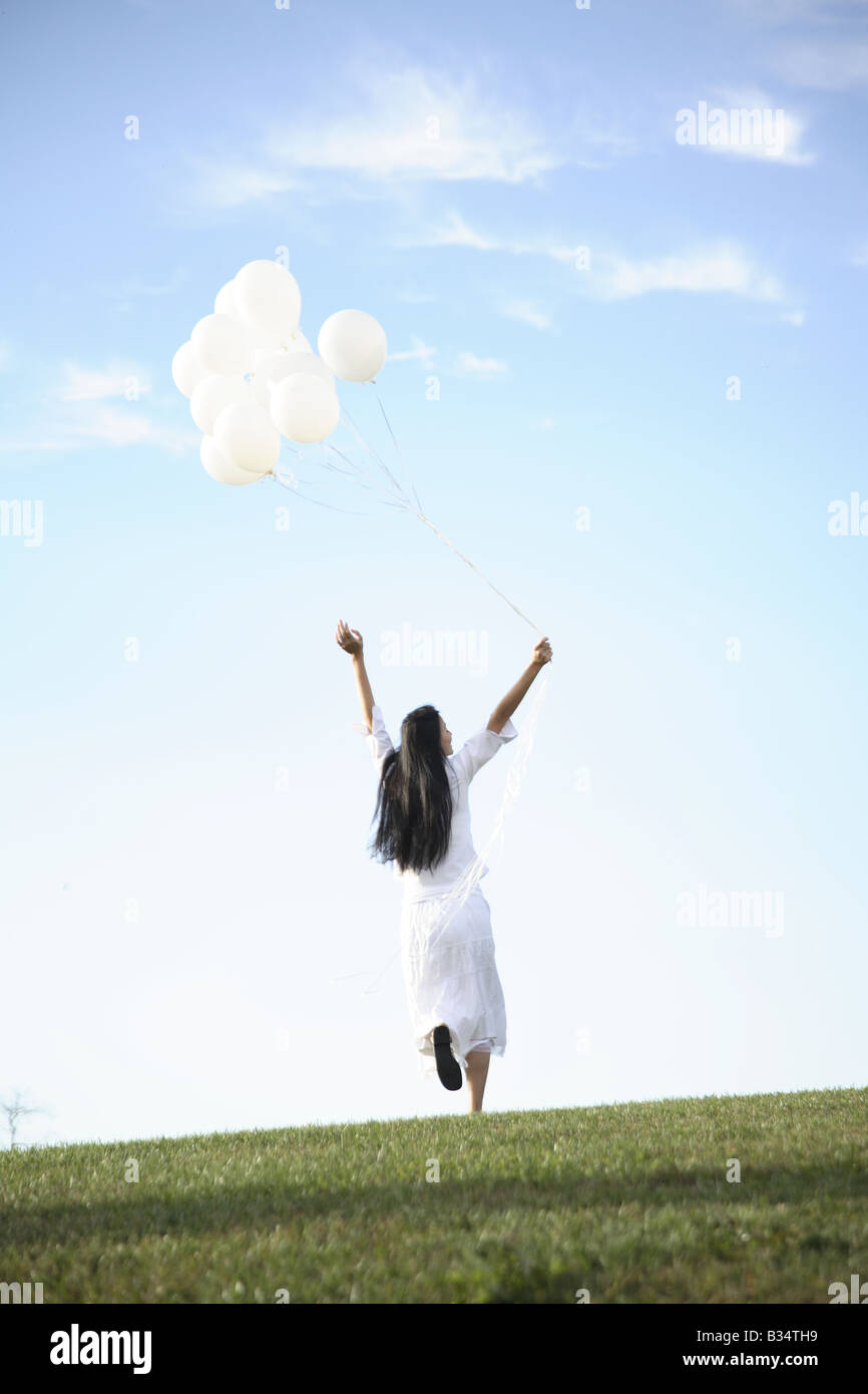Asian woman with white balloons Stock Photo - Alamy
