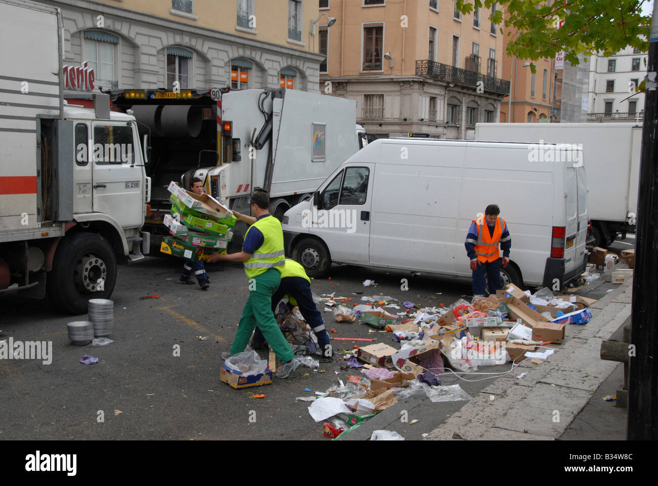 Refuse collectors,collecting rubbish left behind by market traders in ...
