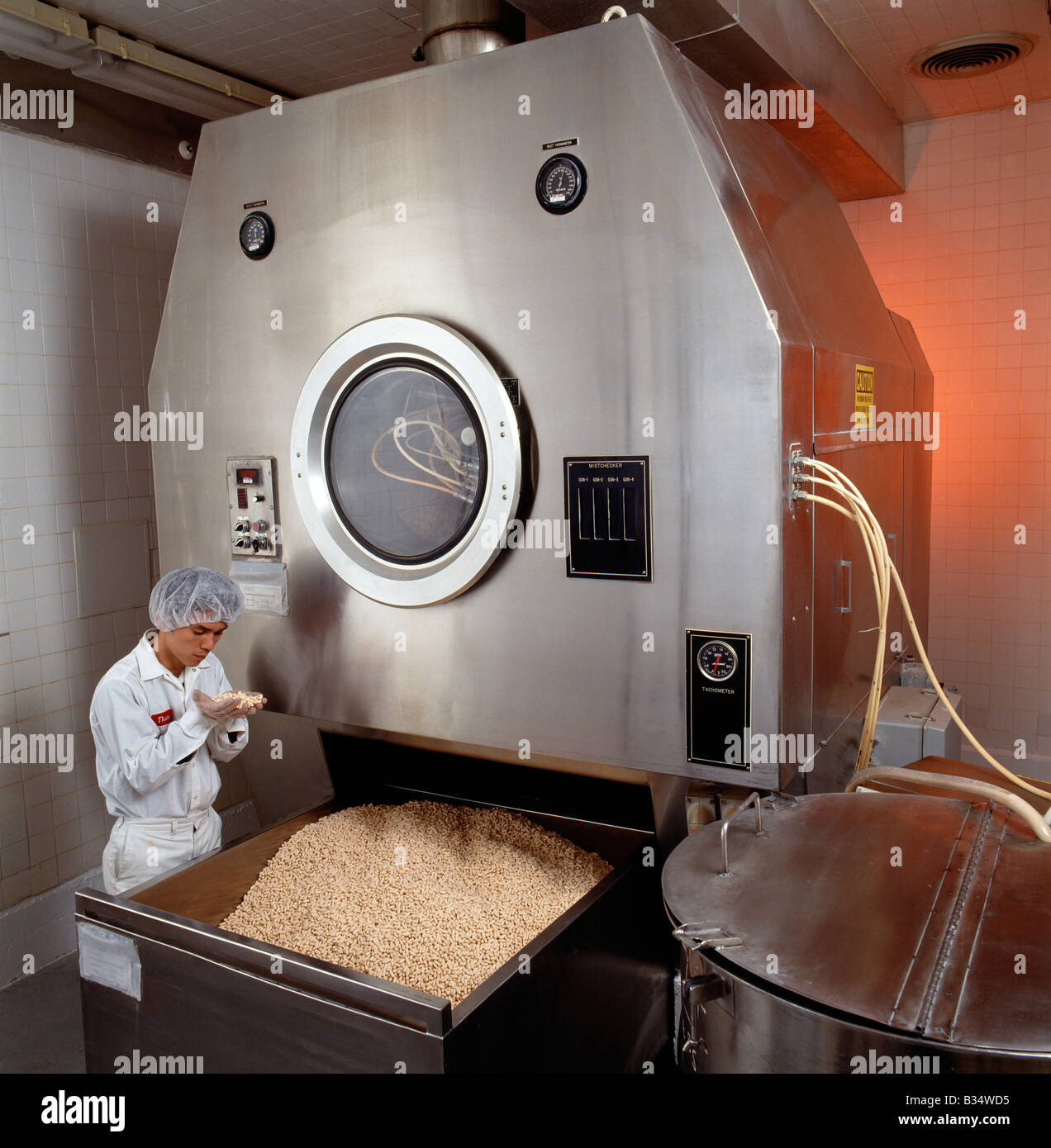 Quality control worker examining tablets in a pharmaceutical ...