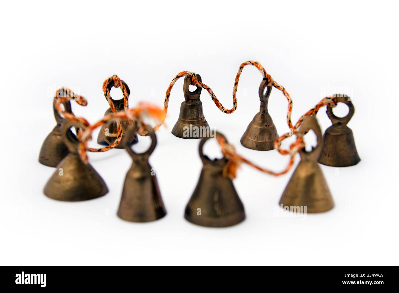 Small bells on a thread, white background Stock Photo - Alamy