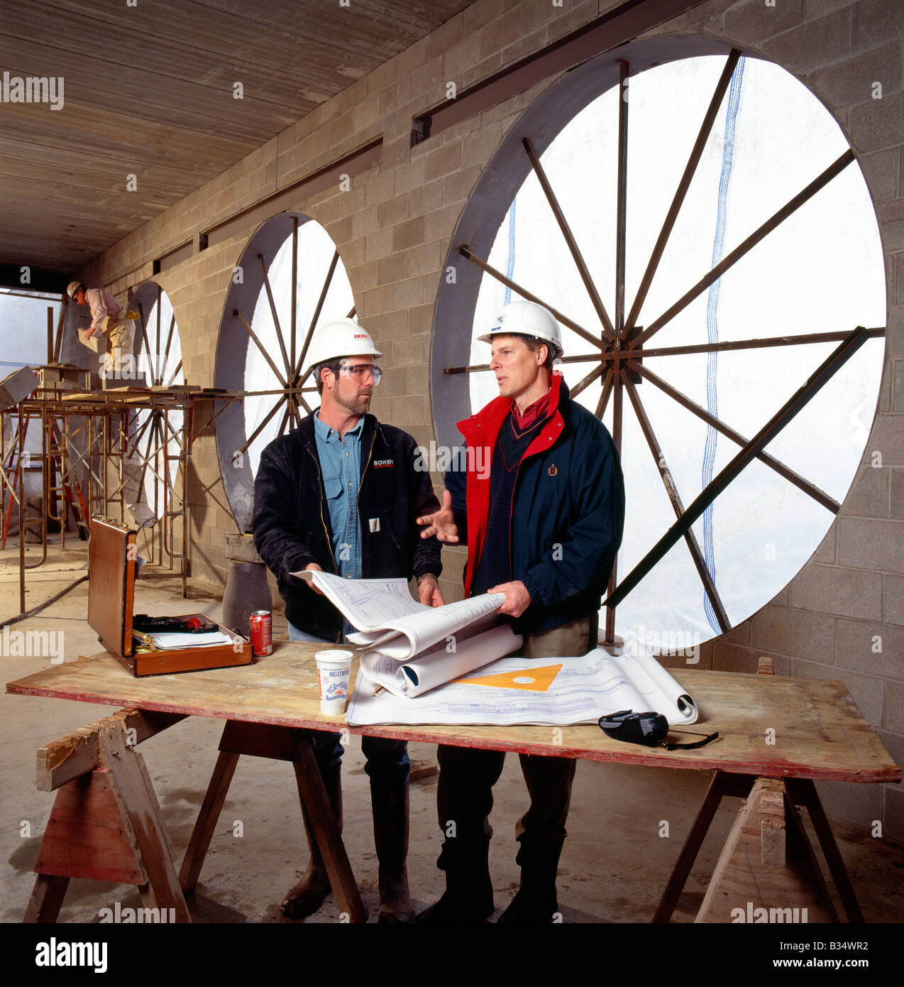 Engineers reviewing construction drawings for water treatment plant ...