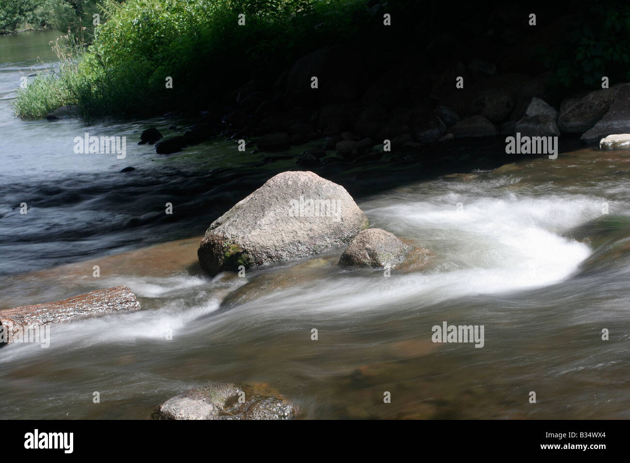 Stream flowing around rock Brainard's Bridge park Waupaca Wisconsin ...