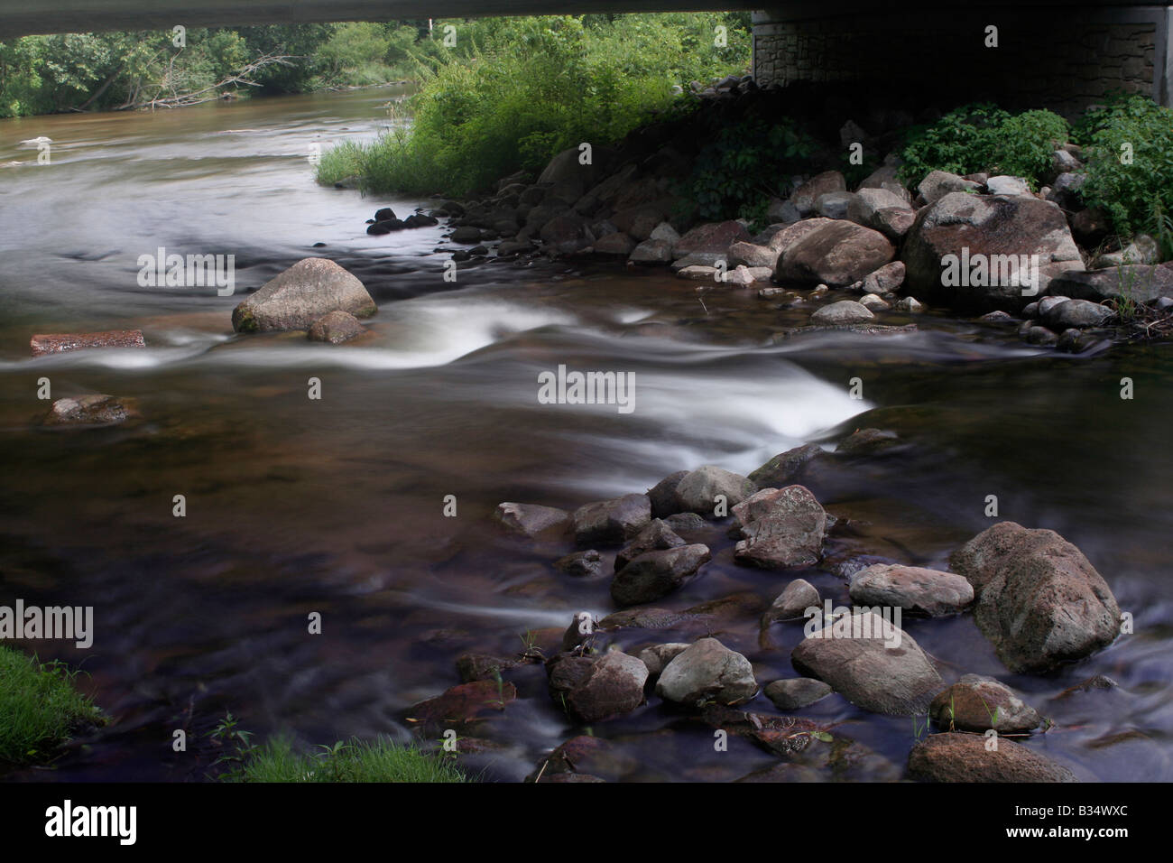 Stream flowing under bridge hi-res stock photography and images - Alamy