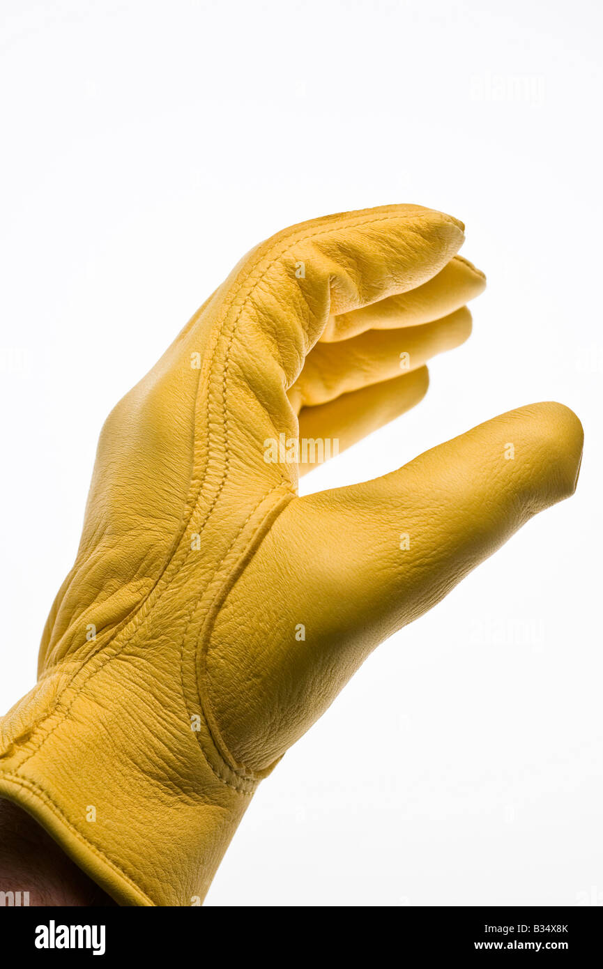 Yellow leather work glove against a white background Stock Photo - Alamy