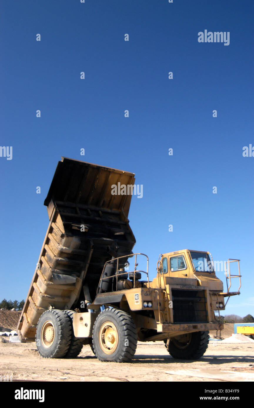 Large yellow dump truck with bed up Stock Photo - Alamy