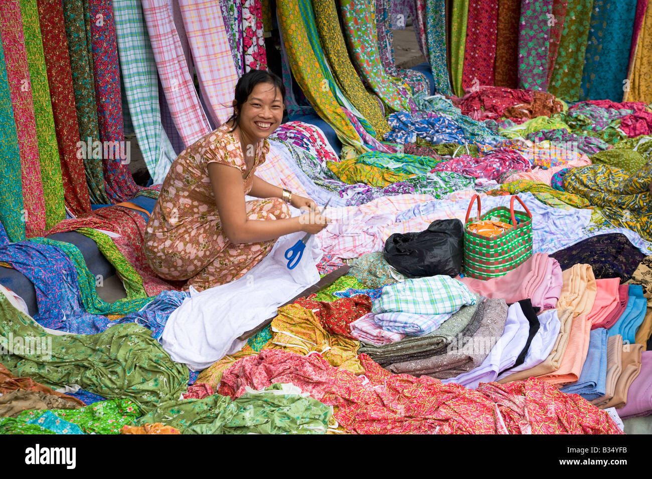 A Vietnamese cloth trader displays her wares Stock Photo - Alamy