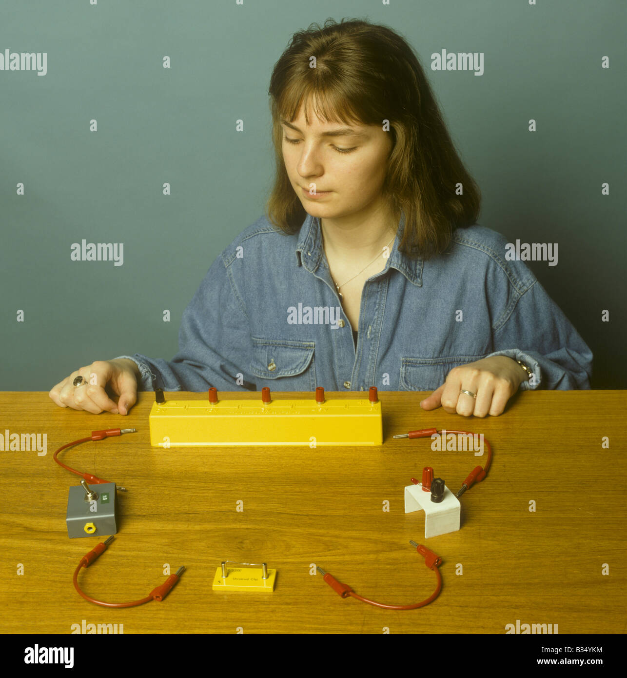 female student looks at components for an electronic circuit Stock ...