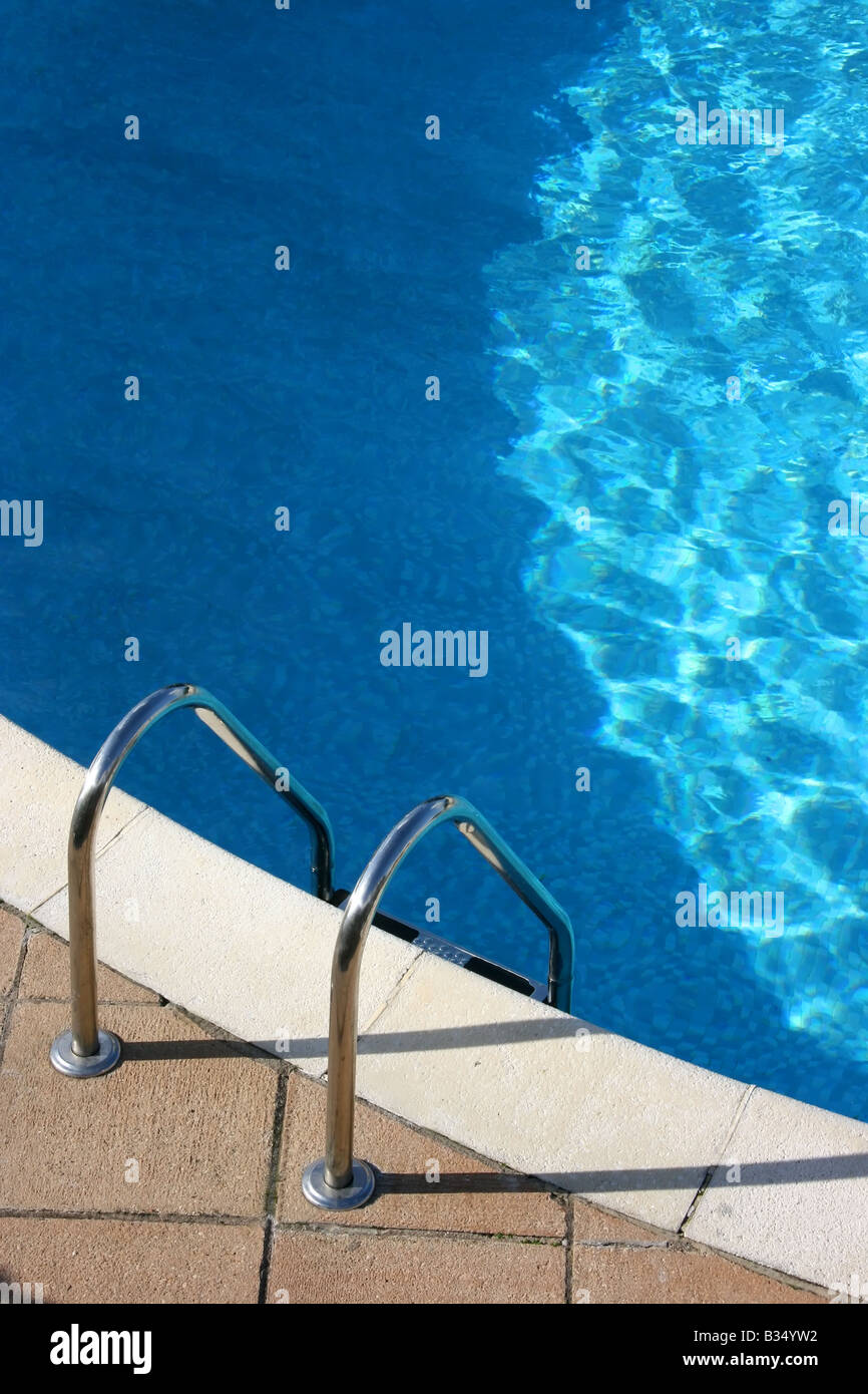 summer evening sunlight playing on rippled water of a swimming pool ...