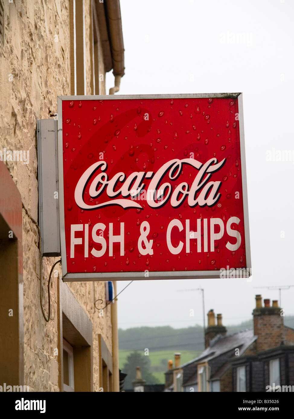 A sign for a fish and chip shop with Coca Cola in Scotland Stock Photo ...