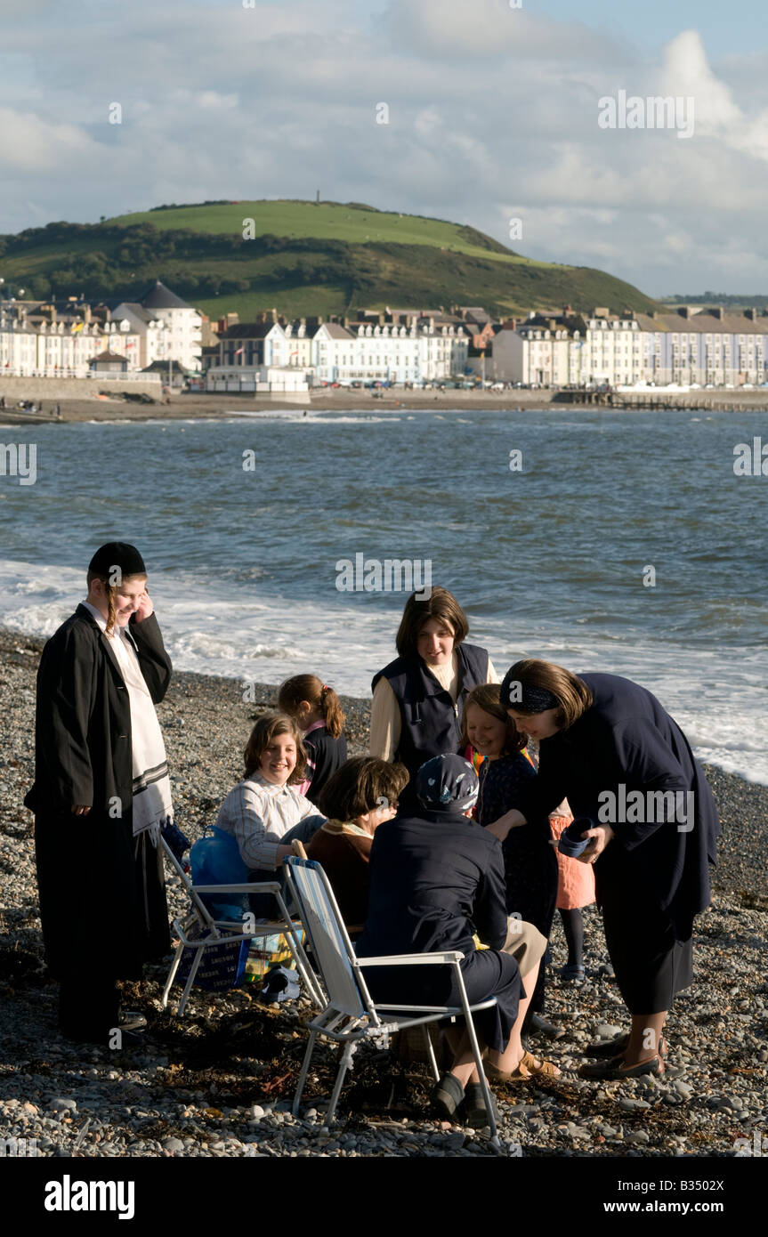 orthodox jewish families on summer holiday on the beach in Aberystwyth ...