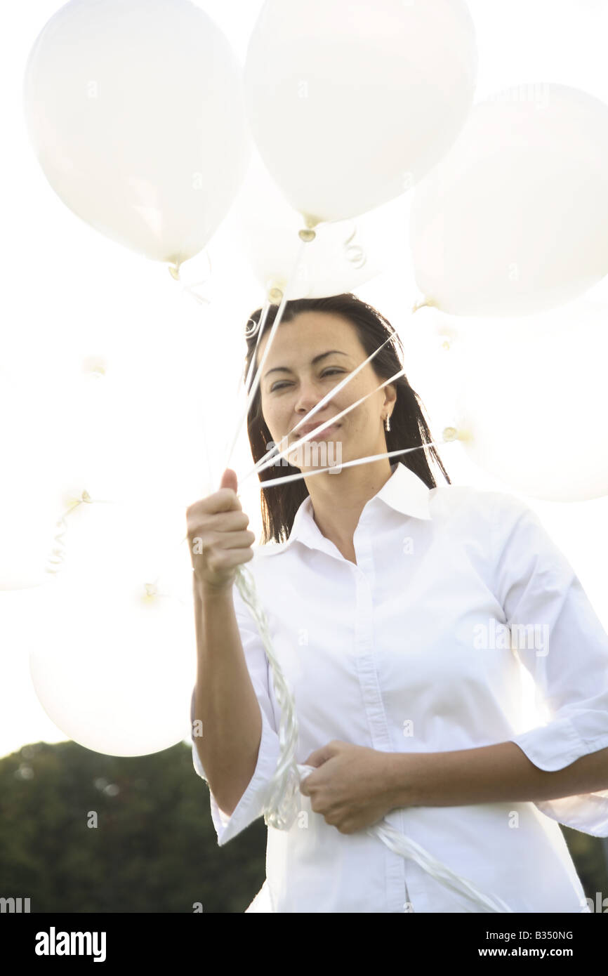 Asian woman with white balloons Stock Photo - Alamy