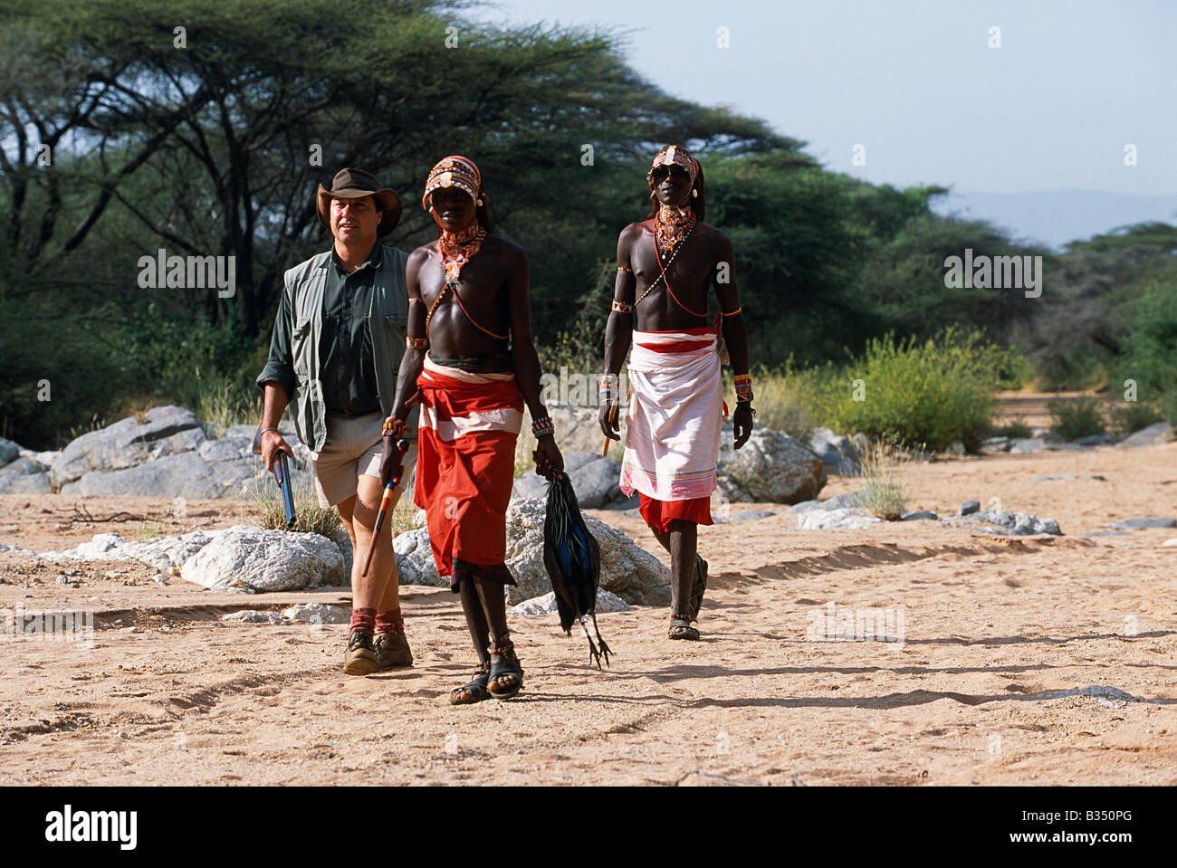 Kenya, Samburu. Samburu morani (warriors) drive and pick up birds on a ...