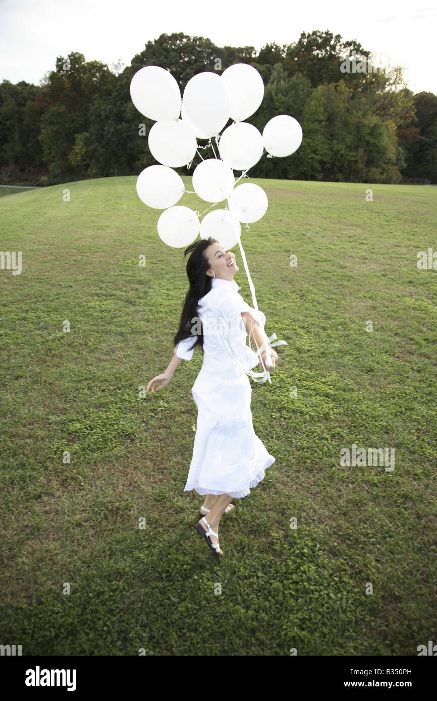 Asian woman with white balloons Stock Photo - Alamy