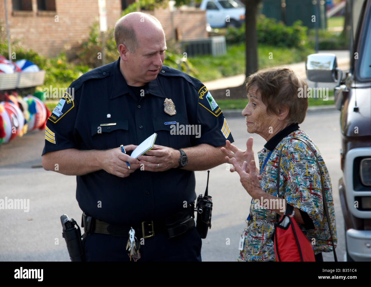 Police Officer Takes A Report Of A Crime From A Senior Citizen Stock